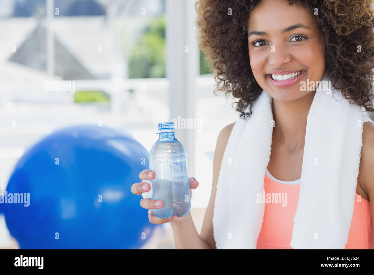 Fit young female holding water bottle at gym Stock Photo - Alamy