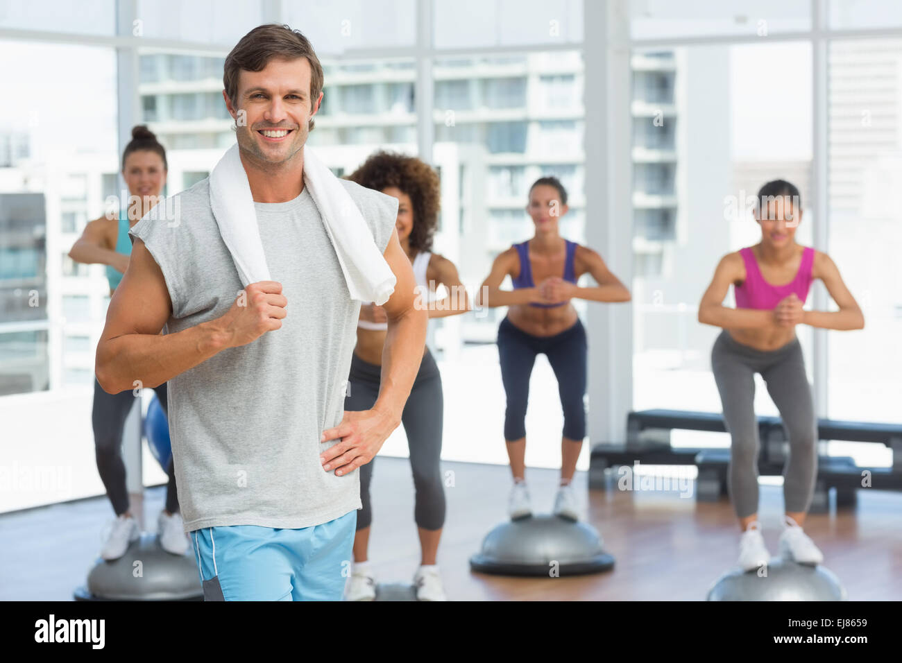 Man with fit people performing step aerobics exercise Stock Photo - Alamy