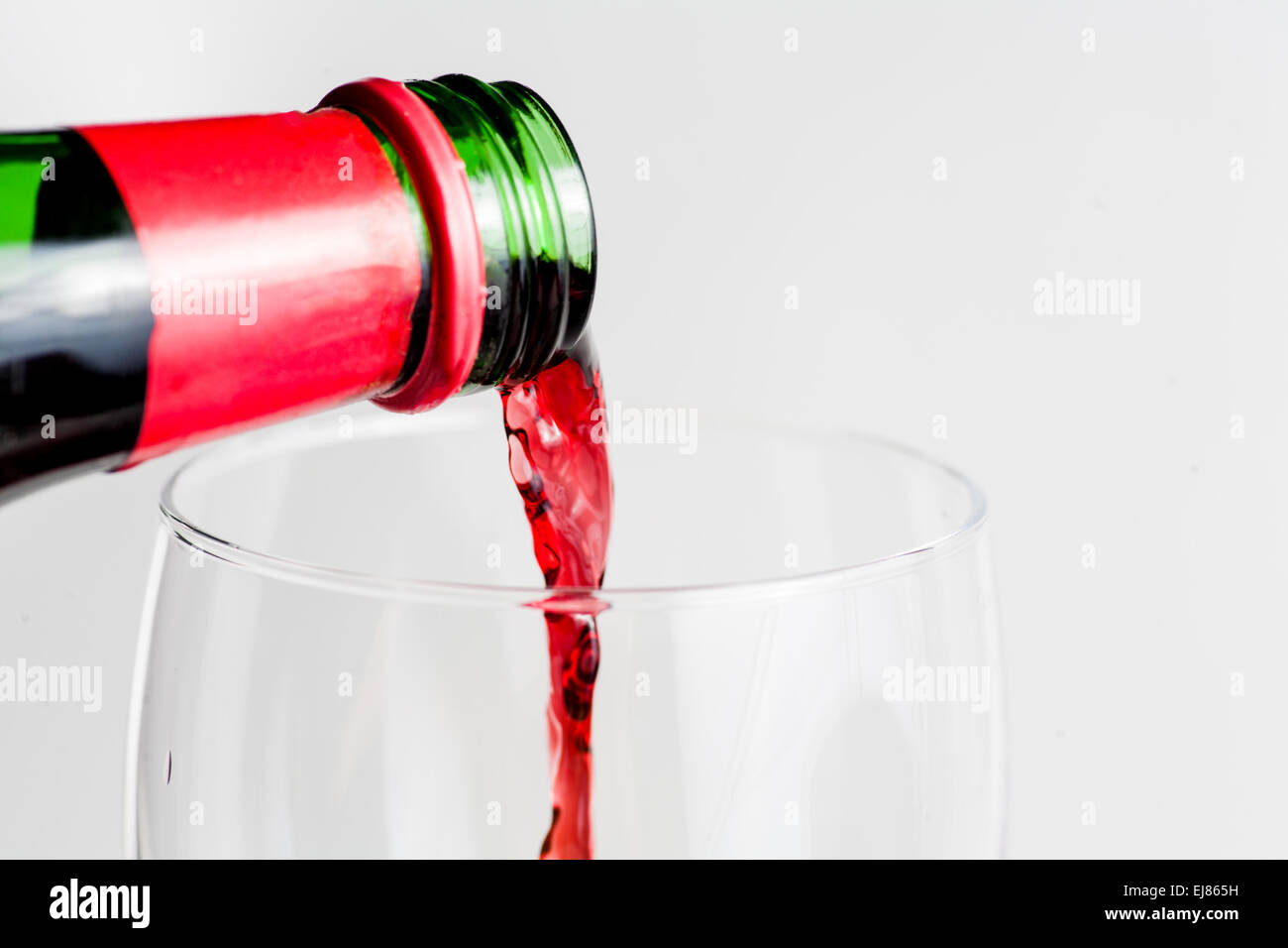 Red wine pouring side view Stock Photo - Alamy