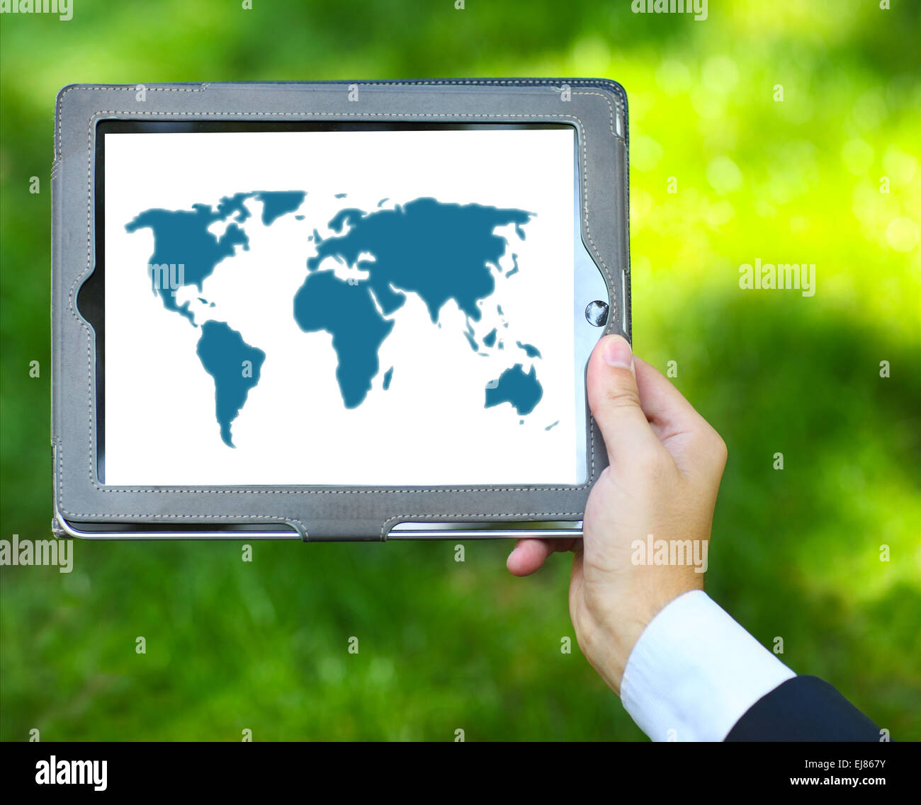 Man holding tablet computer with world map Stock Photo - Alamy