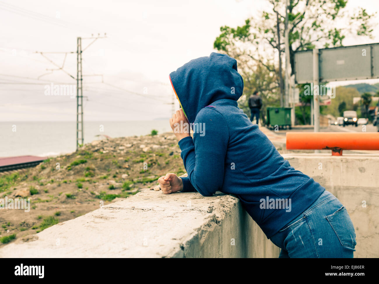 Woman looking over fence hi-res stock photography and images - Alamy