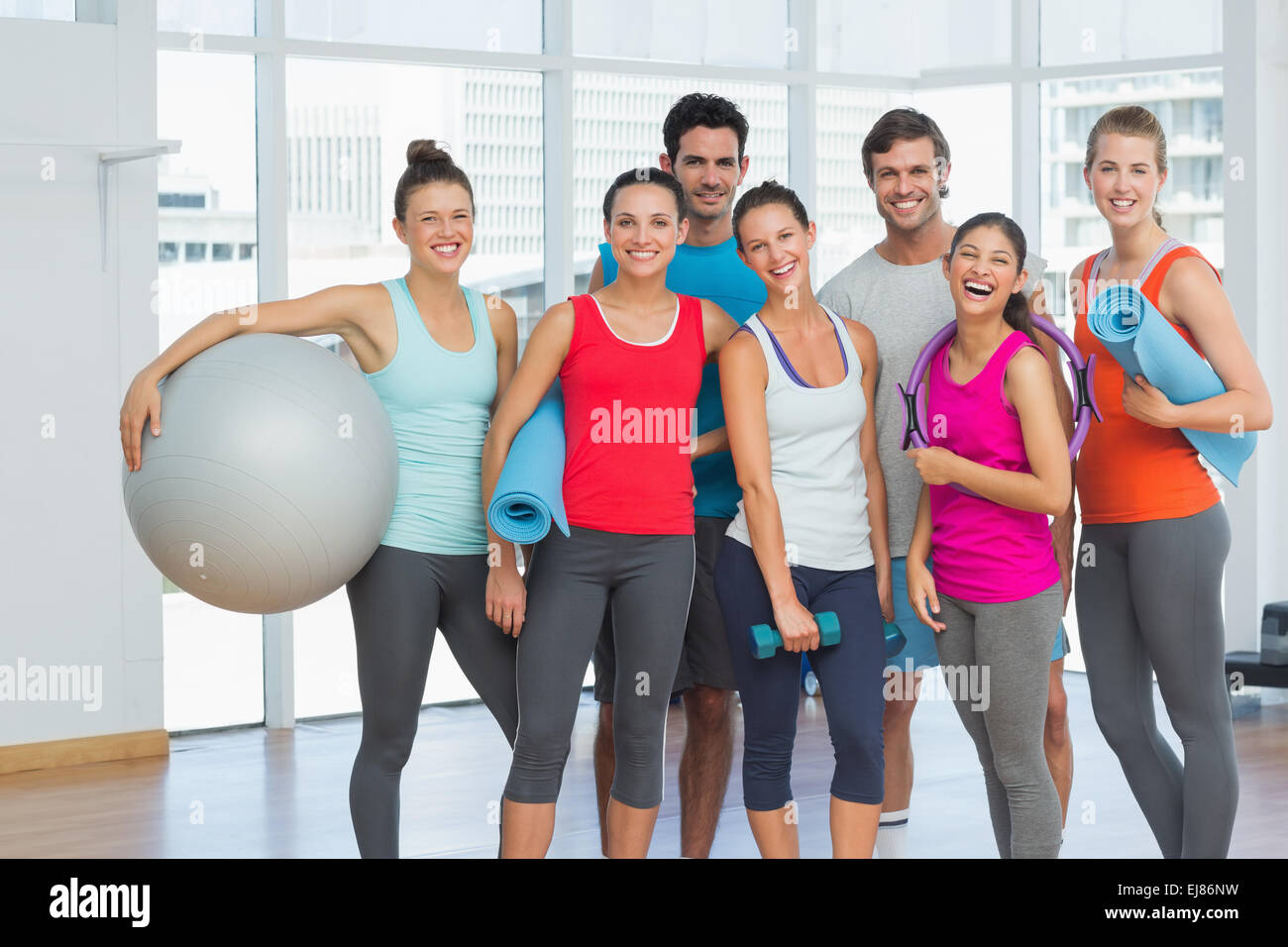 Fit people smiling in a bright exercise room Stock Photo - Alamy