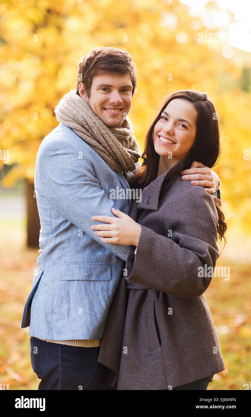 smiling couple hugging in autumn park Stock Photo - Alamy