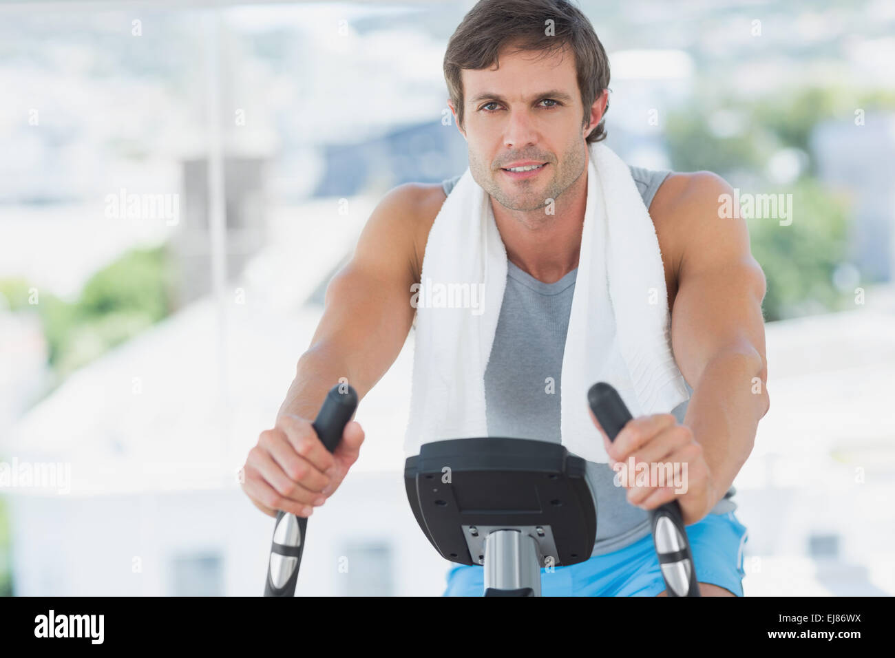 Smiling man working out at spinning class in bright gym Stock Photo - Alamy