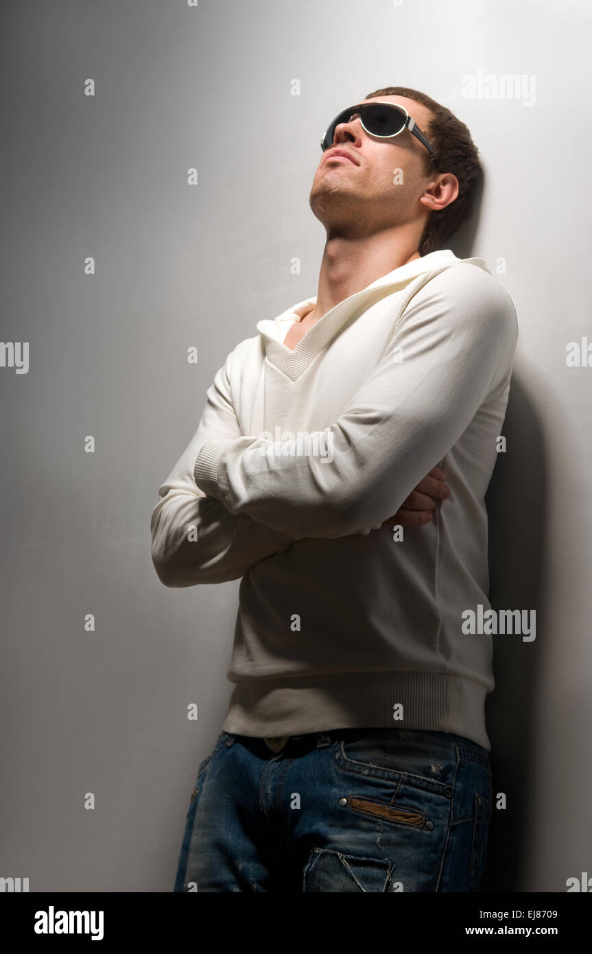 man standing near a wall Stock Photo - Alamy