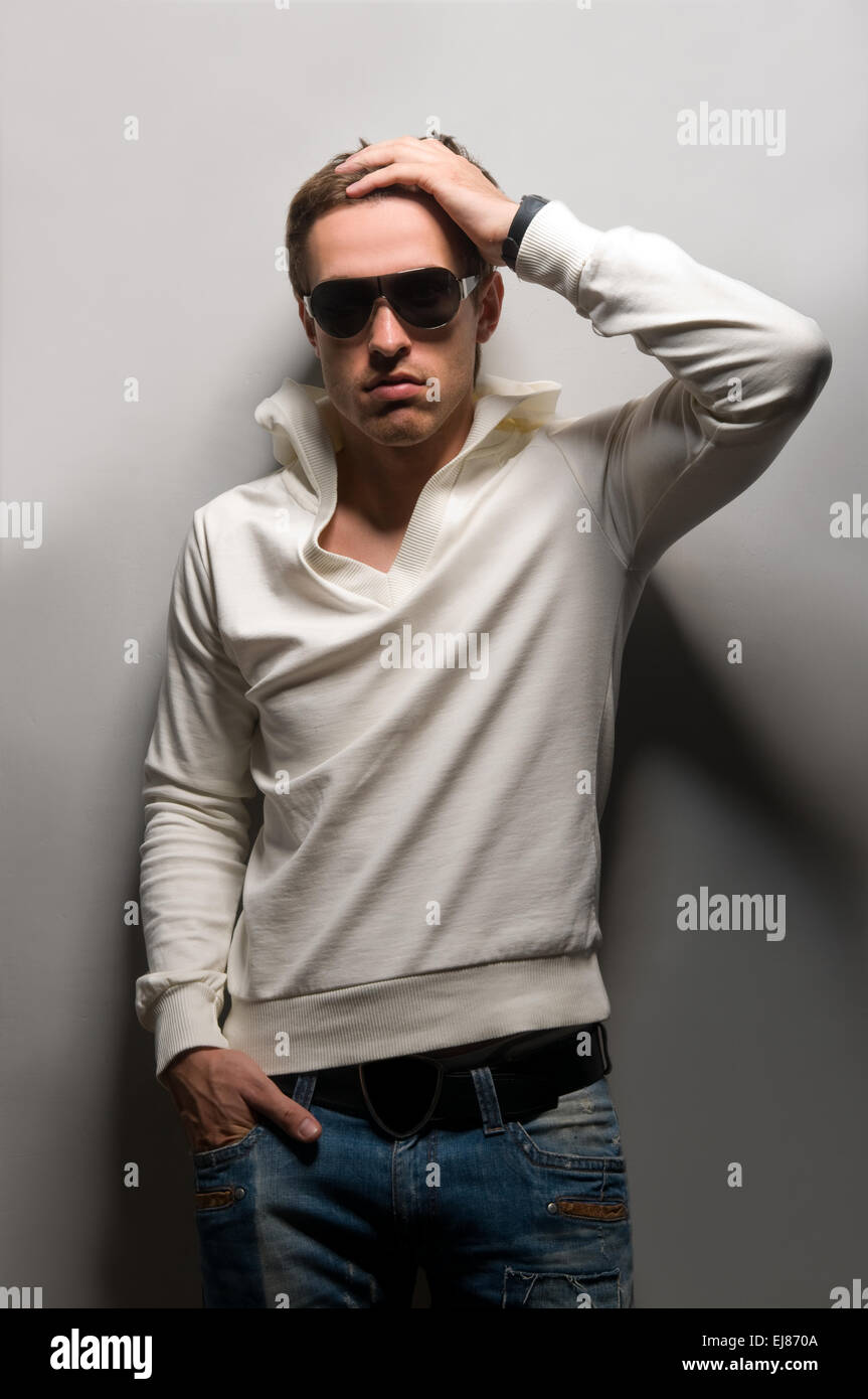 man standing near a wall Stock Photo - Alamy