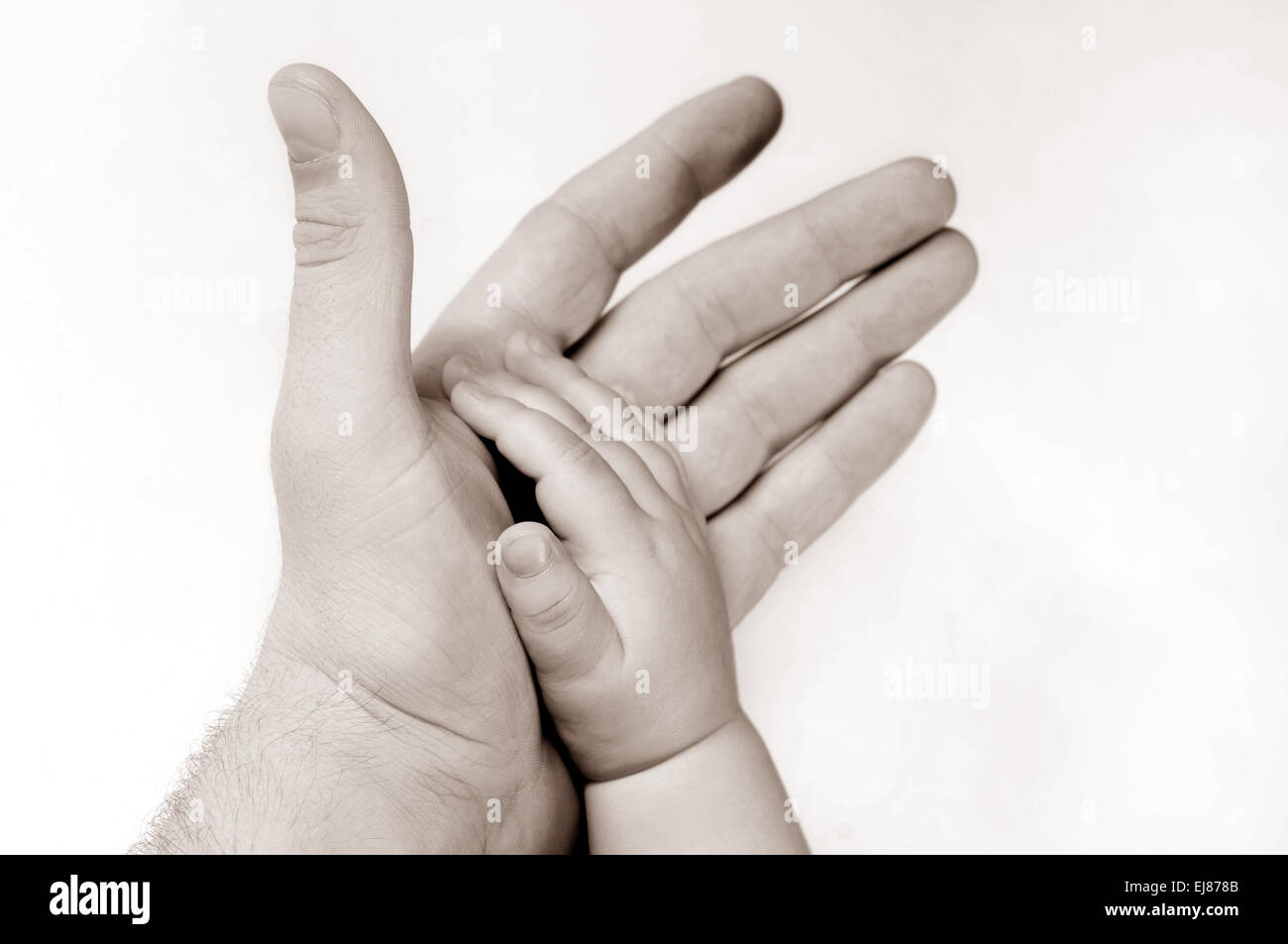 Men's and children's hand Stock Photo - Alamy