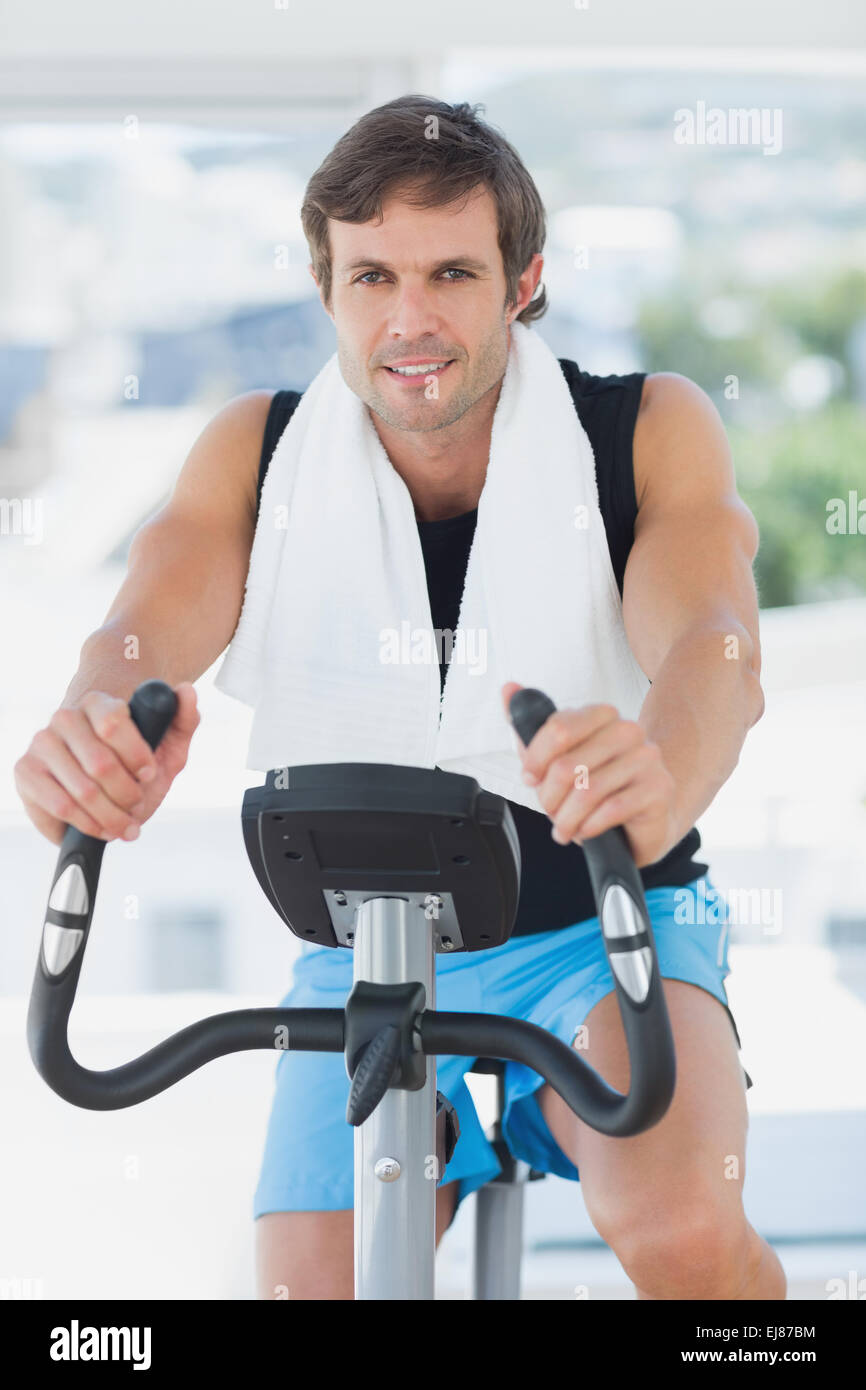 Smiling man working out at spinning class in bright gym Stock Photo - Alamy