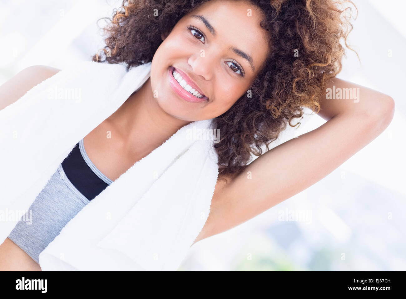 Sporty woman stretching hand behind back in fitness studio Stock Photo ...