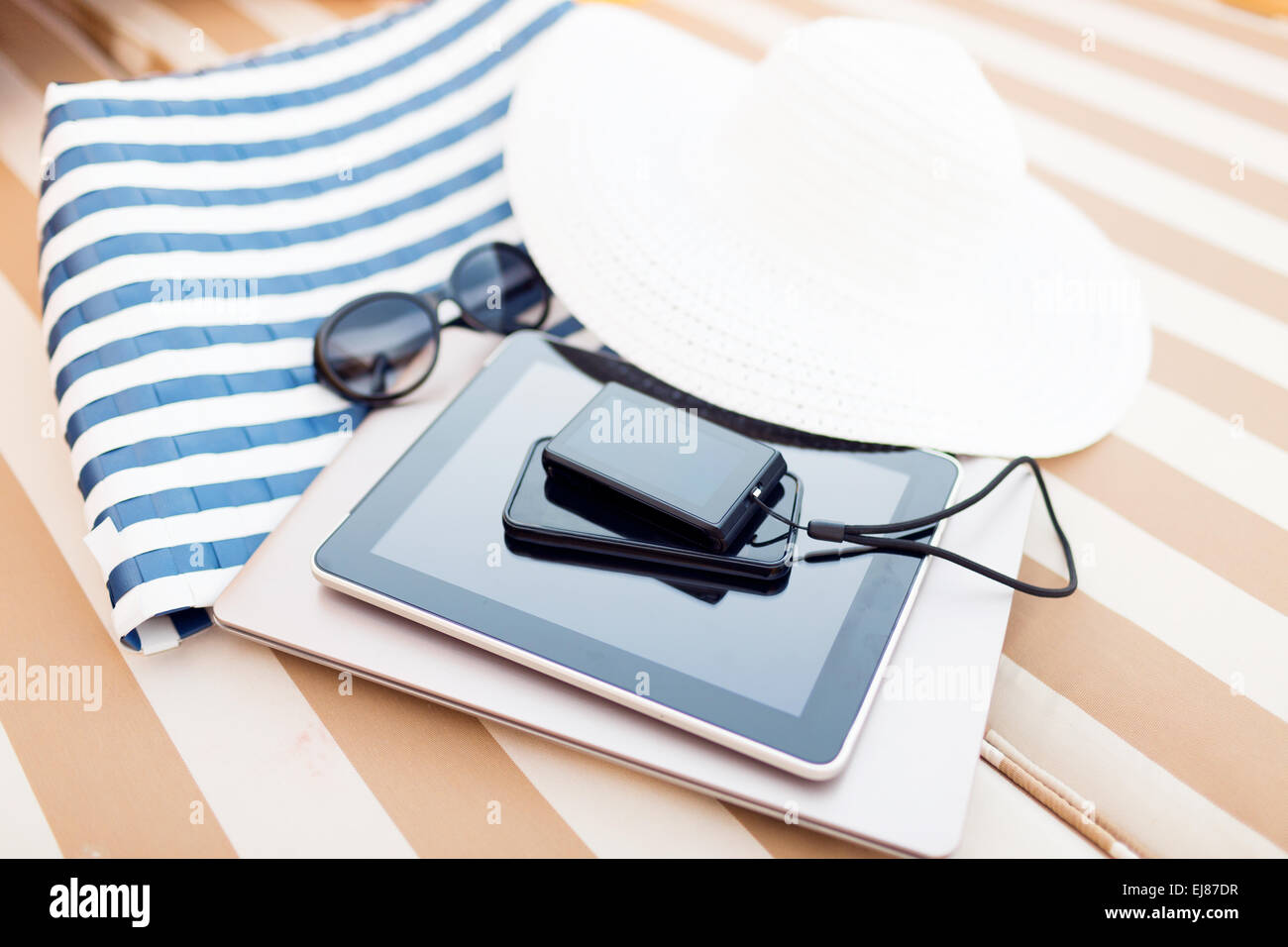 close up of tablet pc and smartphone on beach Stock Photo - Alamy