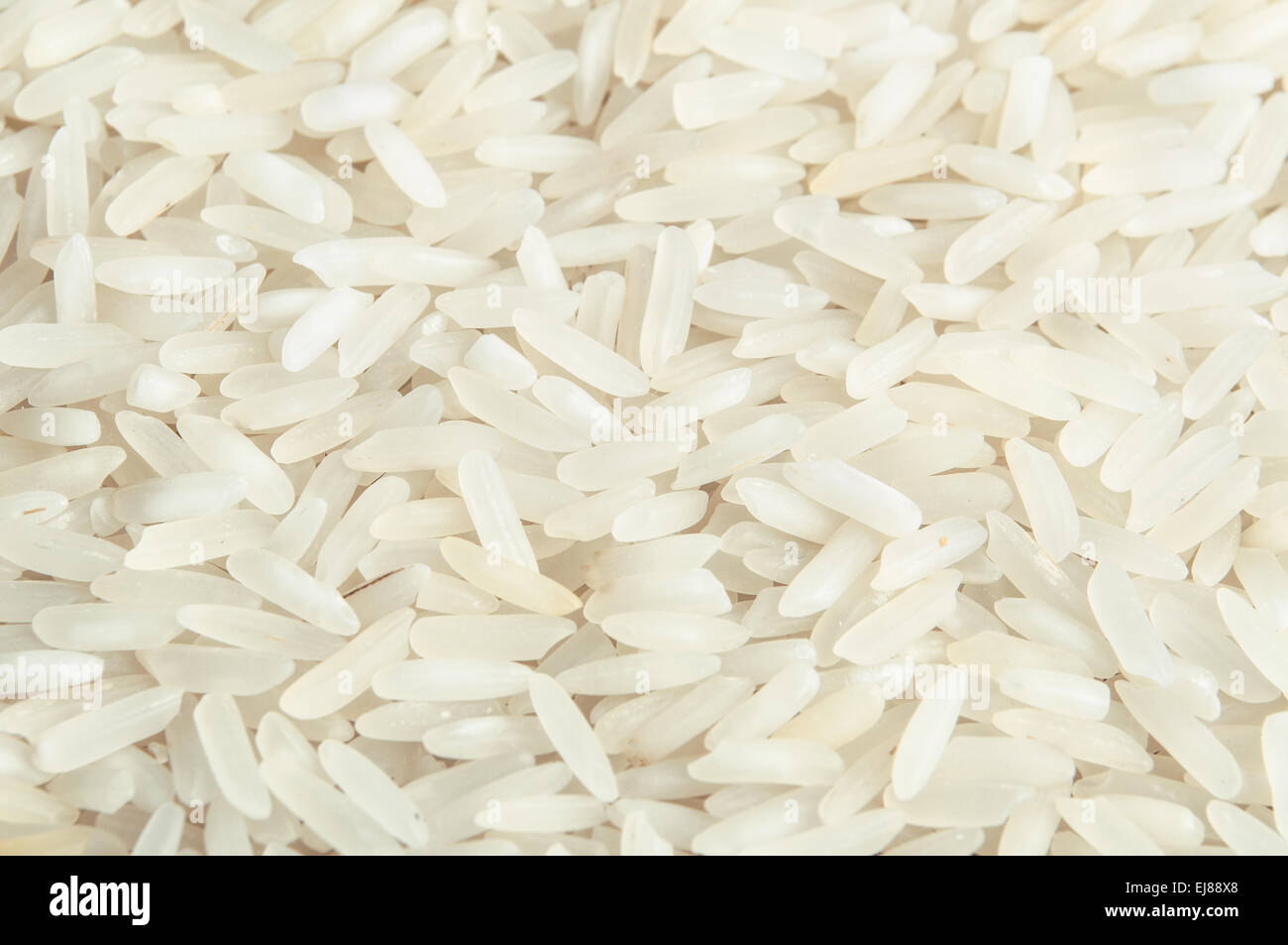 Uncooked white rice background Stock Photo - Alamy