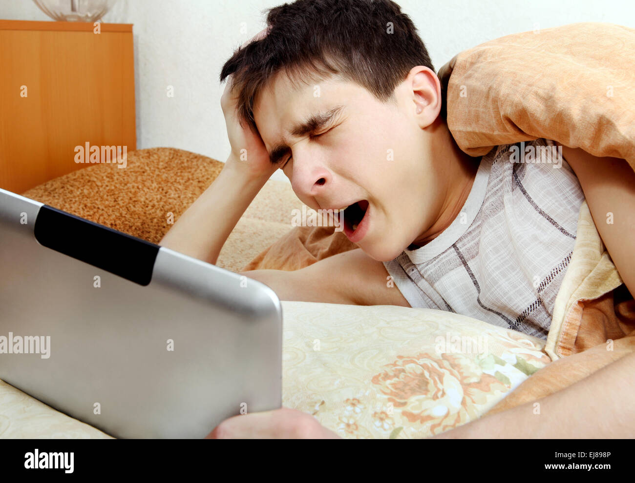 Tired Teenager with Tablet Computer Stock Photo - Alamy