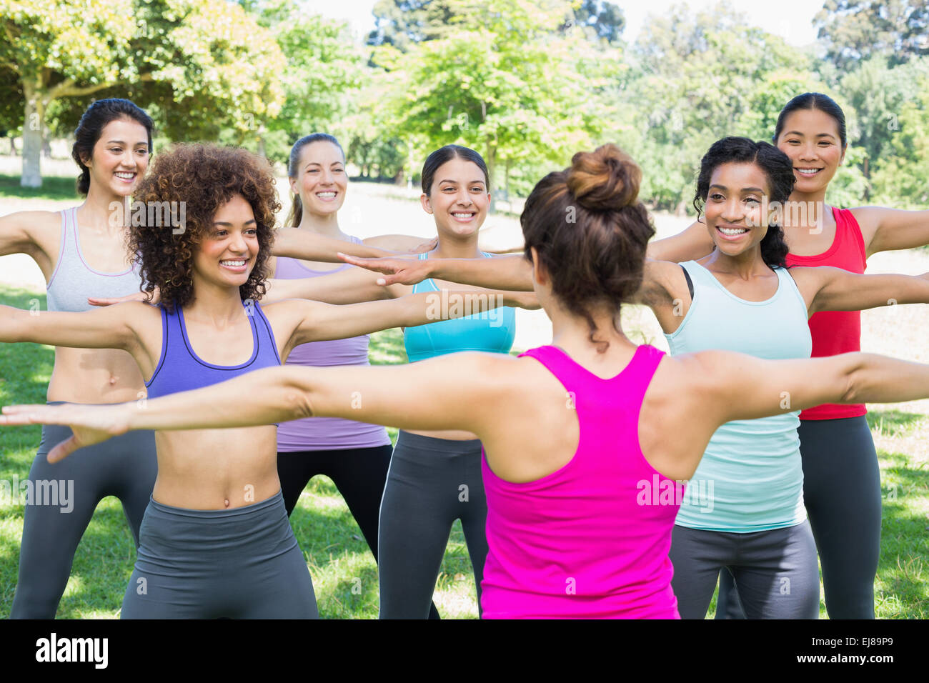 Women exercising with instructor at park Stock Photo - Alamy