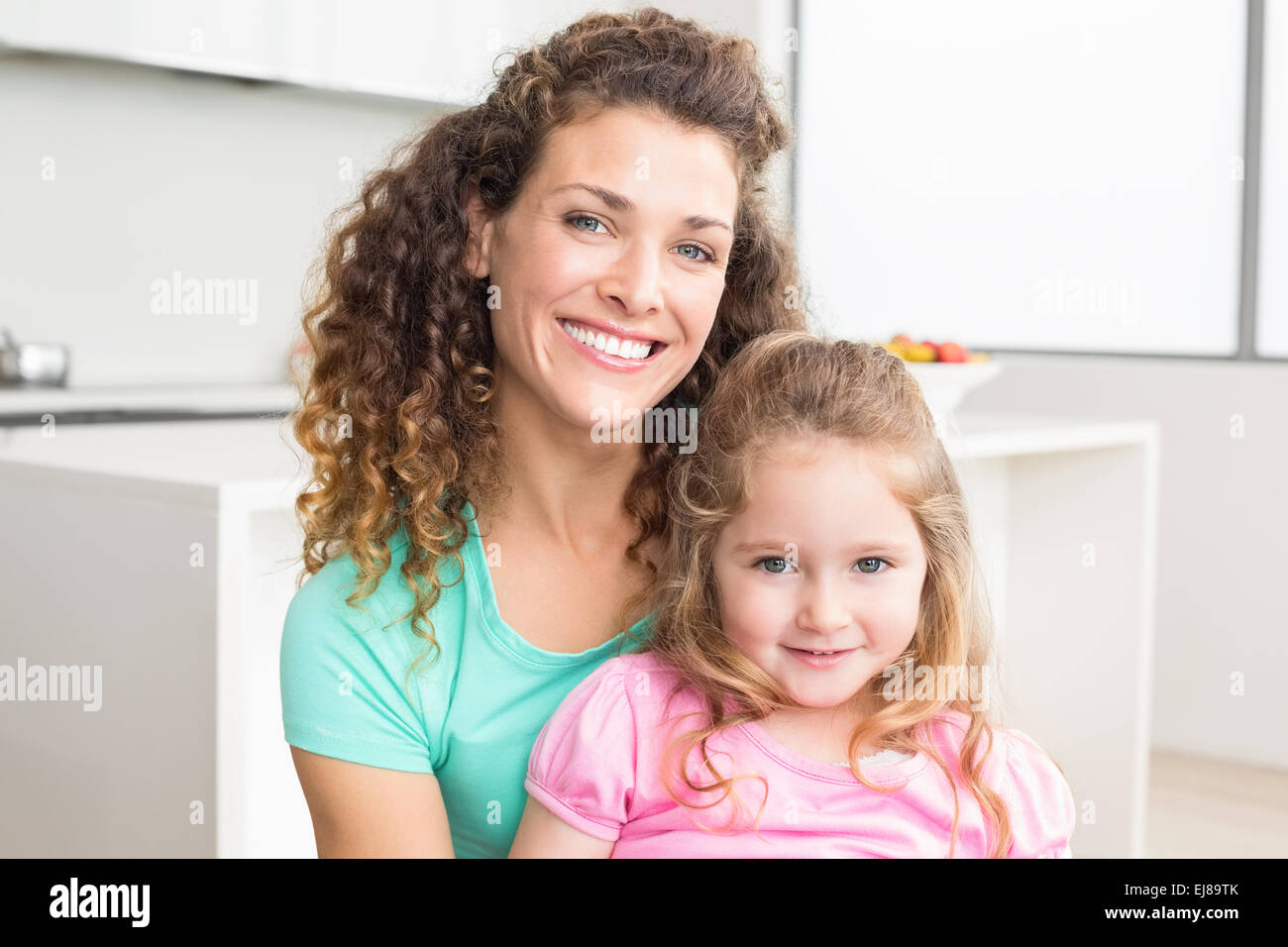 Happy mother and daughter looking at camera Stock Photo - Alamy