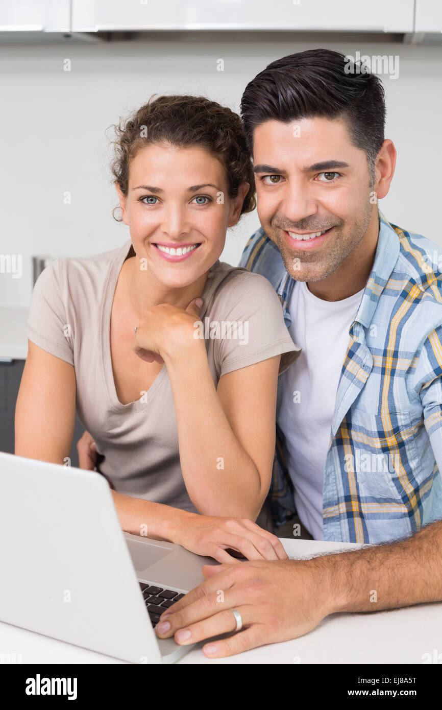 Attractive couple using laptop together Stock Photo - Alamy