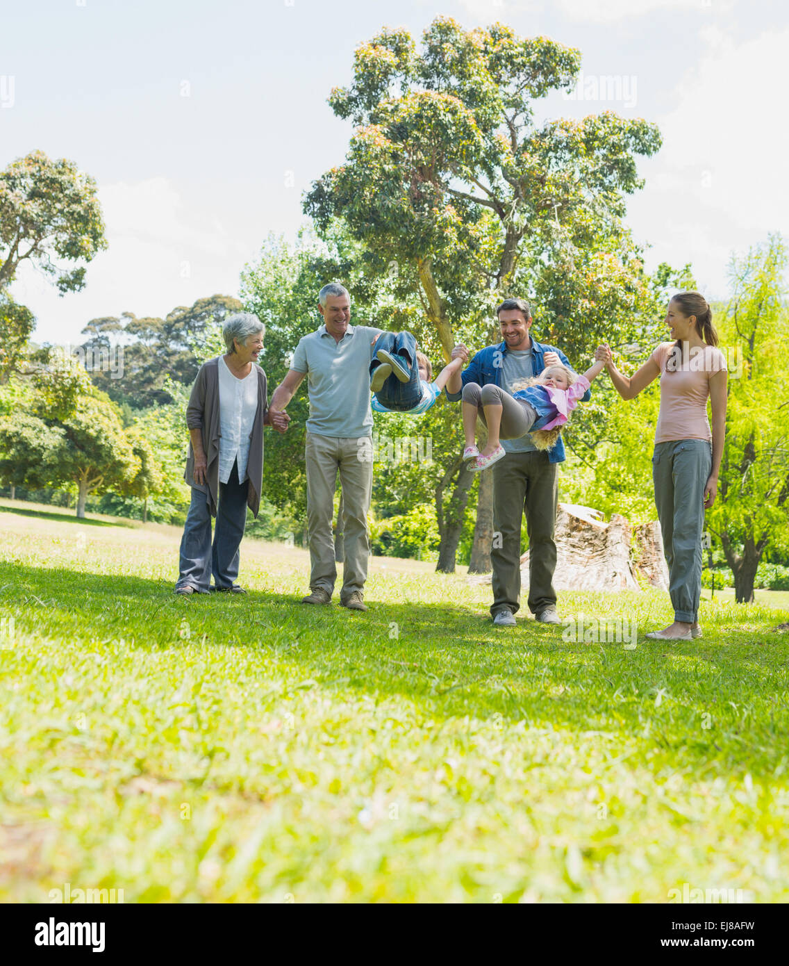 Grandparents walking granddaughter in park hi-res stock photography and ...
