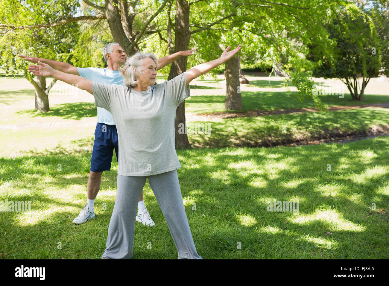 Senior couple stretching arms hi-res stock photography and images - Alamy