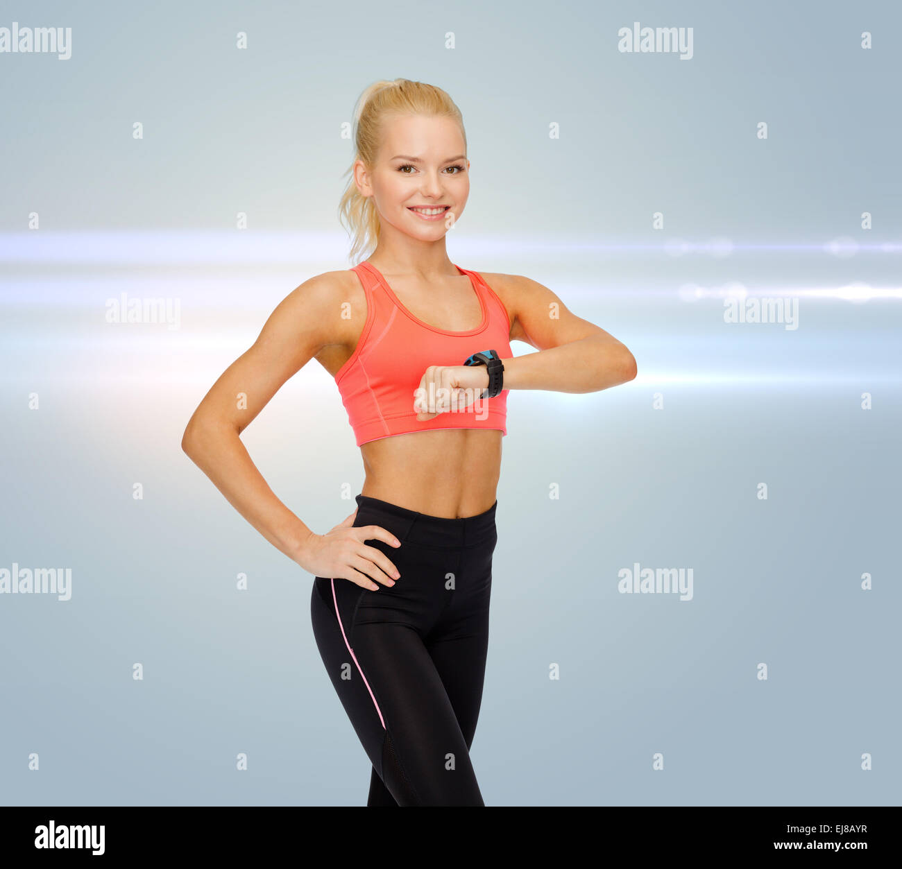 smiling woman with heart rate monitor on hand Stock Photo - Alamy