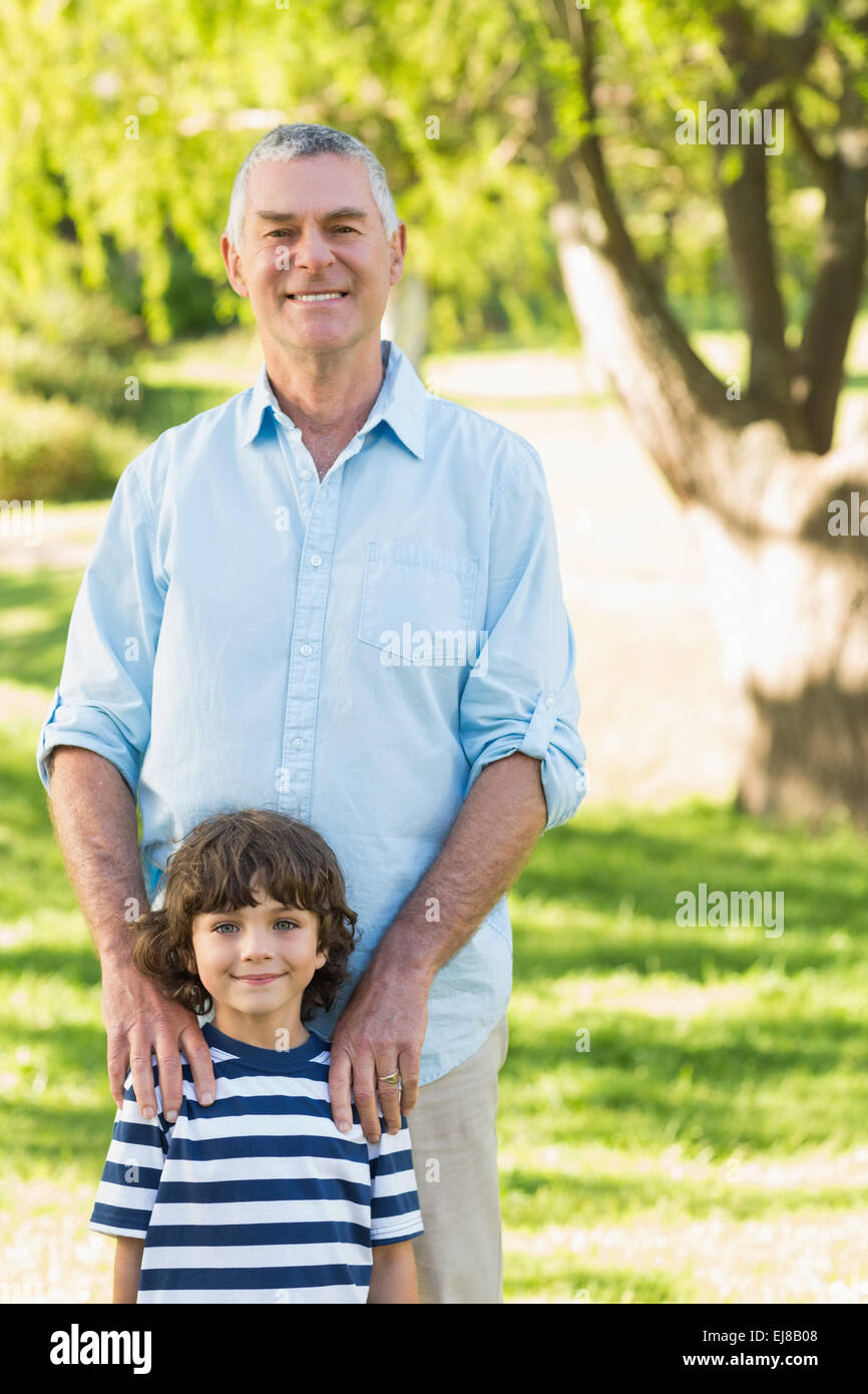 Grandfather and son standing at park Stock Photo - Alamy