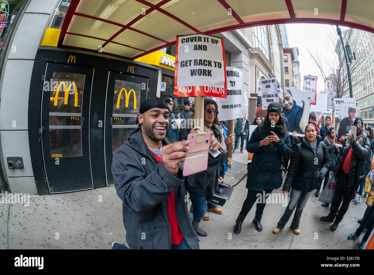 Workers at fast food restaurants and their supporters protest in front ...