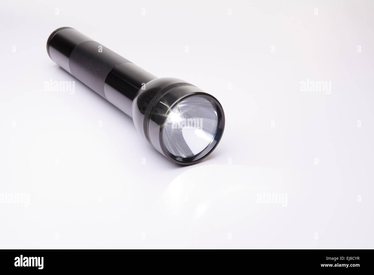 black flashlight over a gray background on the floor Stock Photo - Alamy