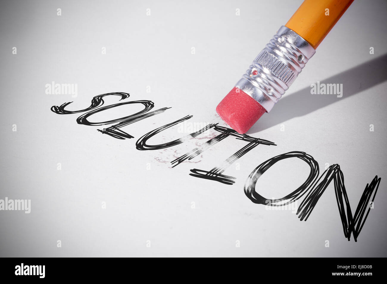 Pencil erasing the word Solution Stock Photo - Alamy