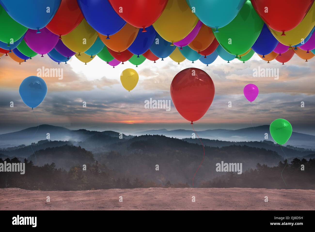 Many colourful balloons above landscape Stock Photo - Alamy