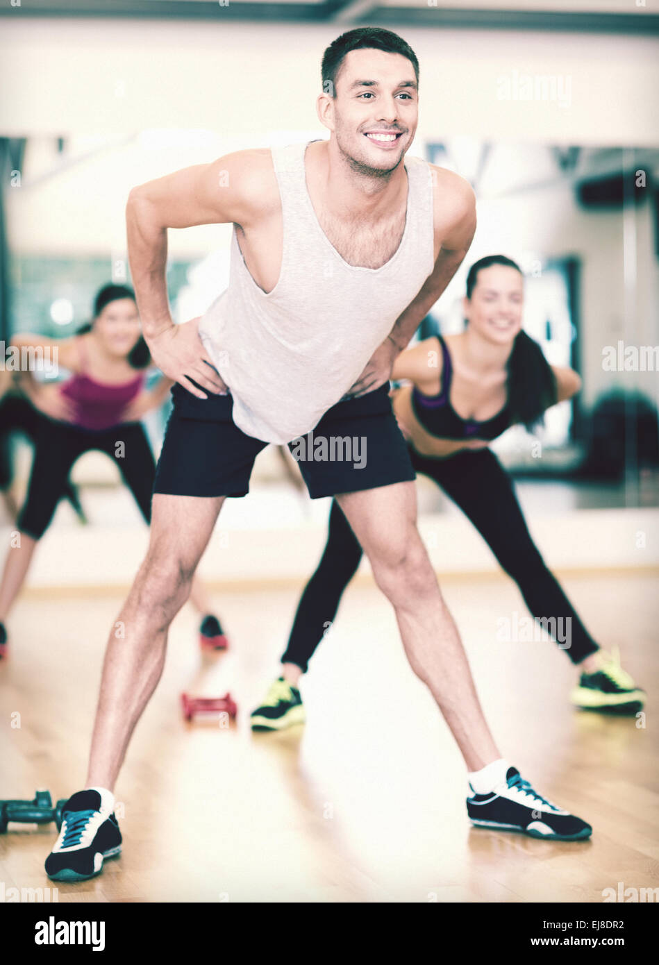 smiling male trainer working out in the gym Stock Photo - Alamy
