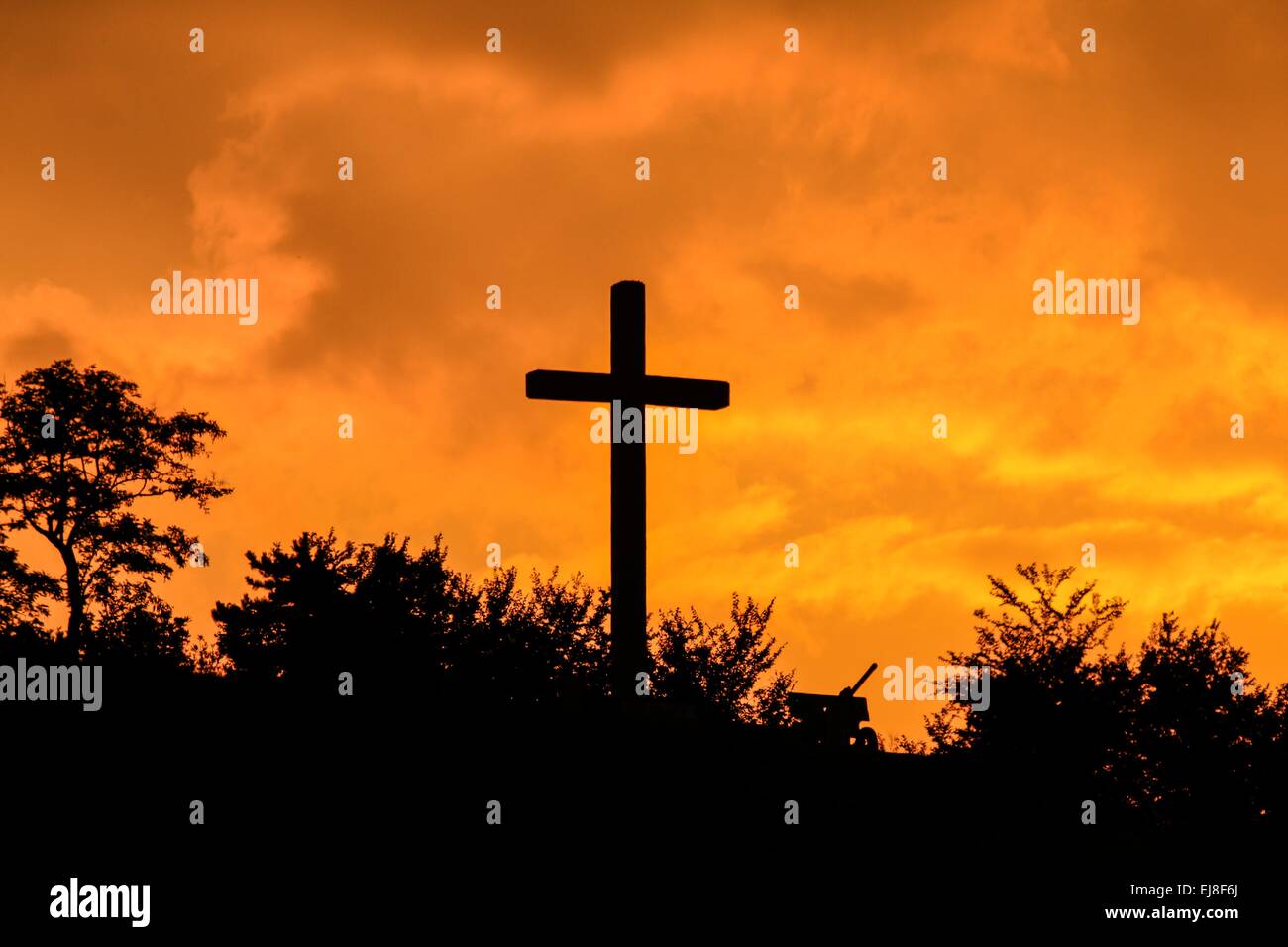 Sunrise over christian cross monument Stock Photo - Alamy