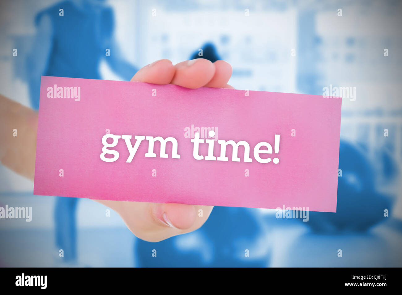 Woman holding pink card saying gym time Stock Photo - Alamy