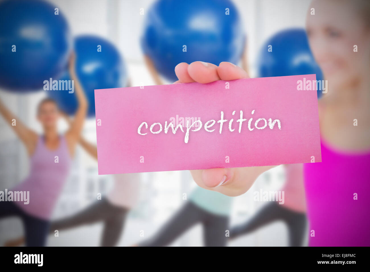 Fit blonde holding card saying competition Stock Photo - Alamy