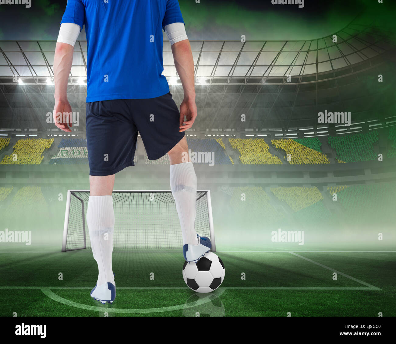 Football player standing with ball Stock Photo - Alamy