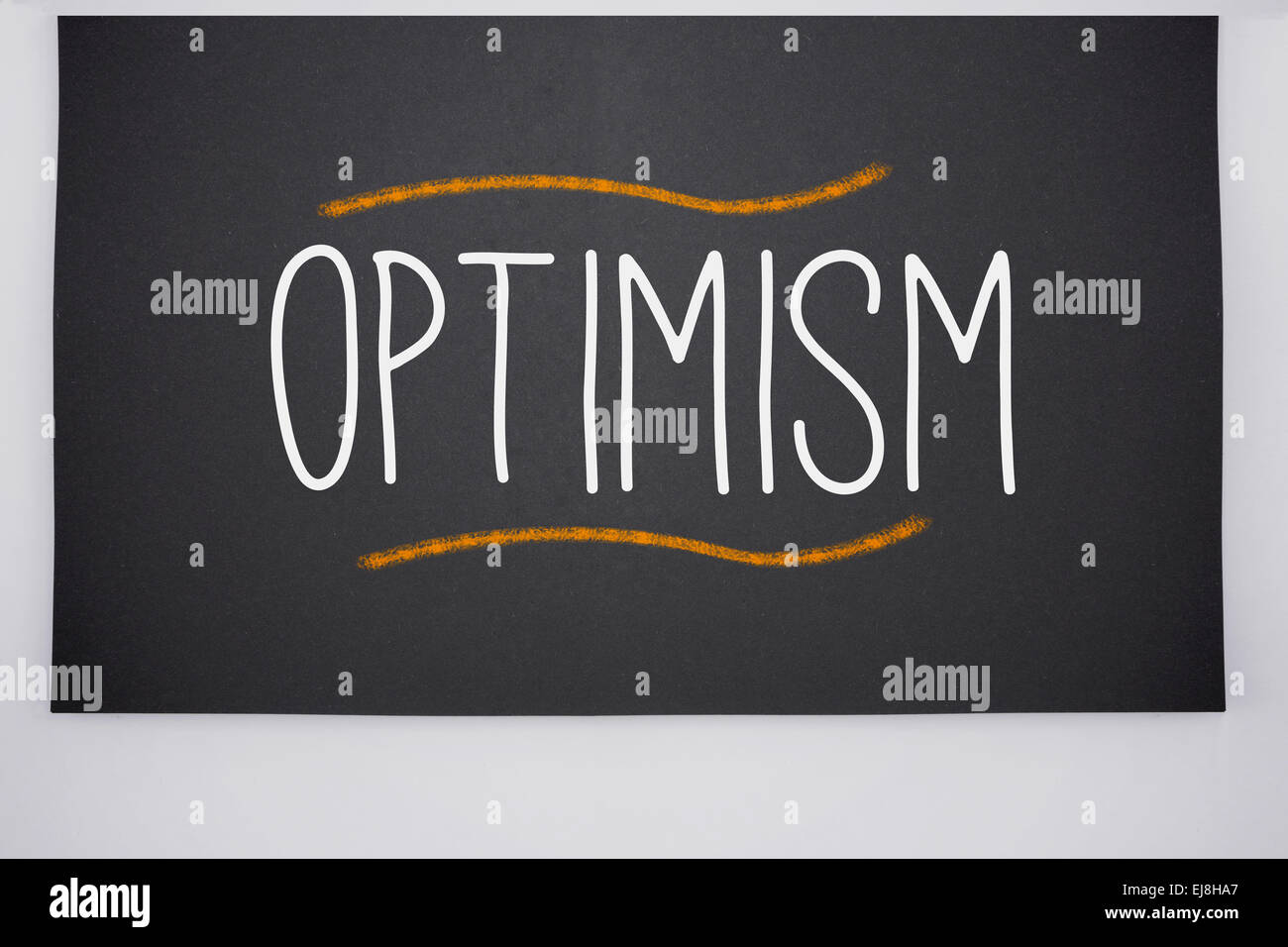 Optimism written on big blackboard Stock Photo - Alamy