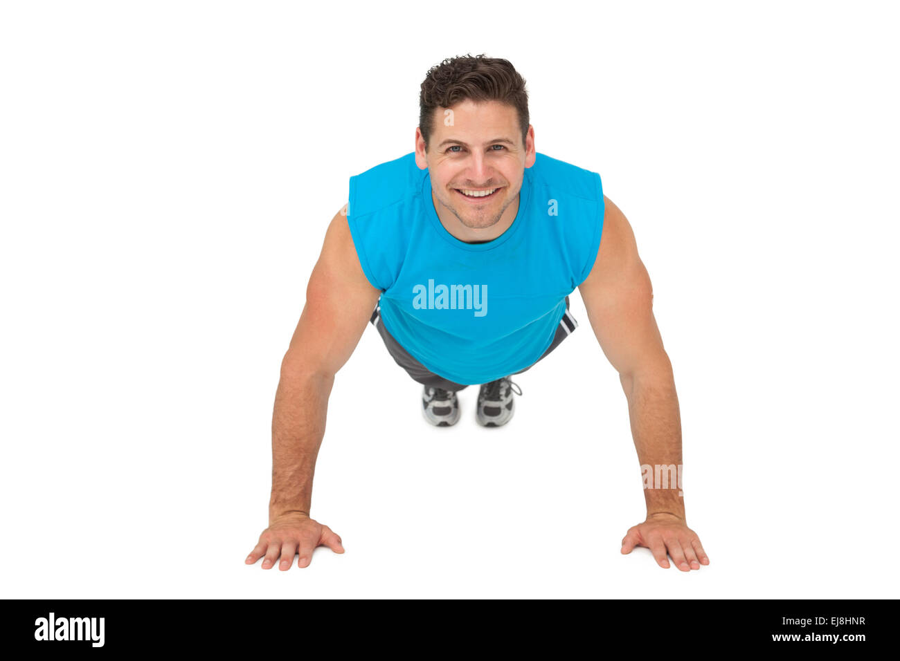 Portrait of a smiling young man doing push ups Stock Photo - Alamy