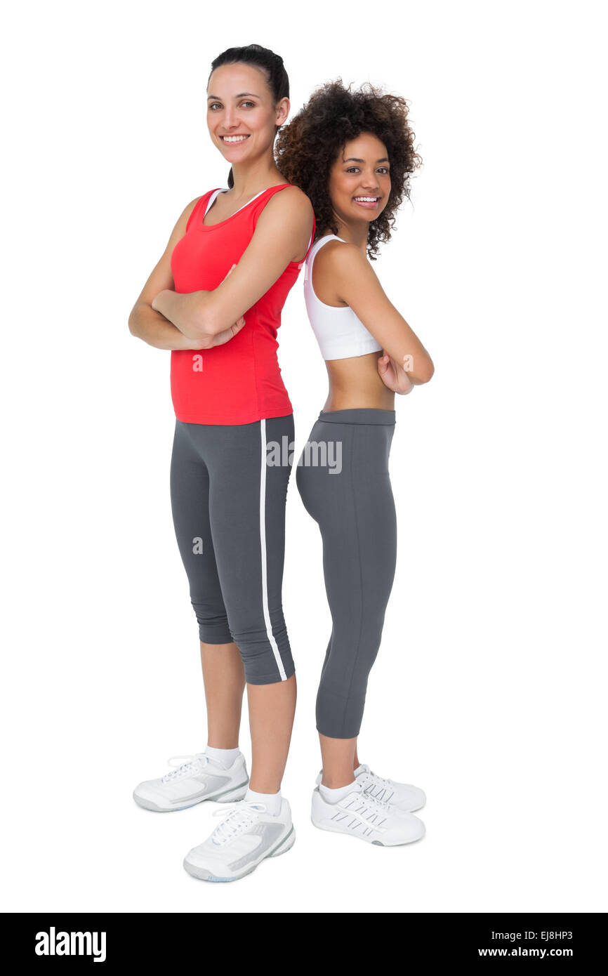 Portrait of two fit young women with arms crossed Stock Photo - Alamy