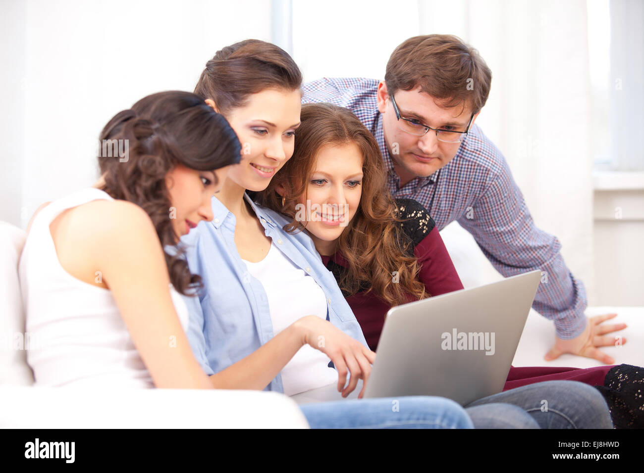 four students and a notebook Stock Photo - Alamy