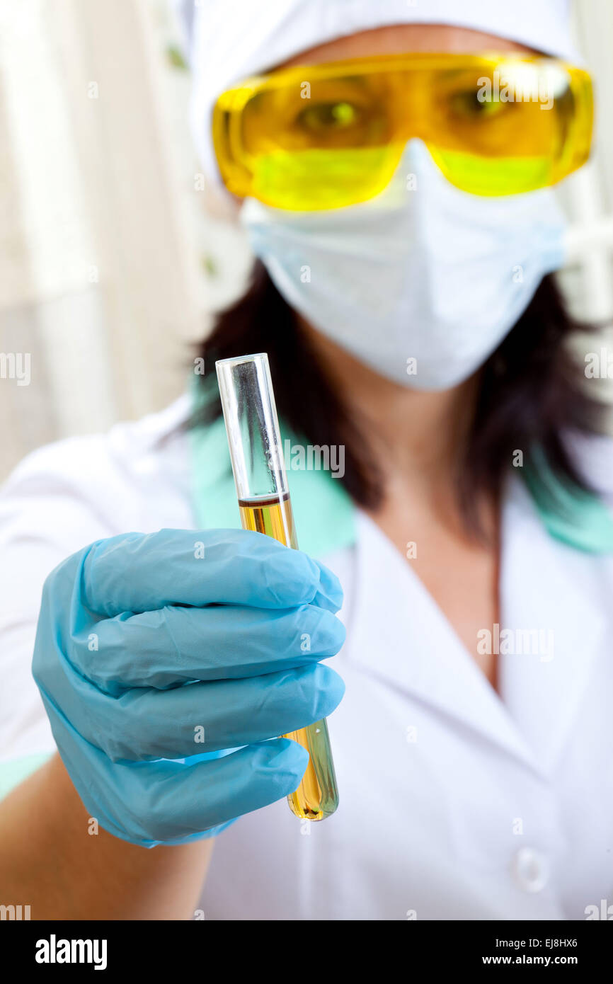 woman doctor shows a test tube of yellow solution Stock Photo - Alamy