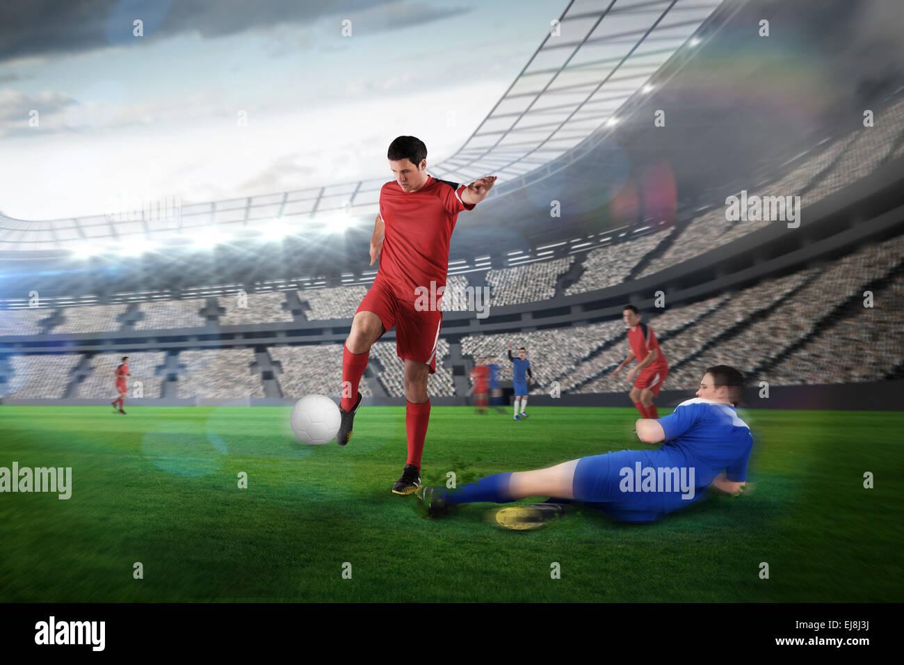 Football player in red kicking Stock Photo - Alamy