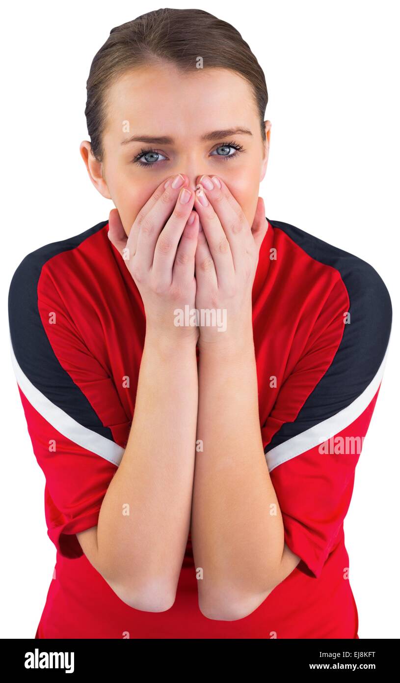 Nervous football fan in red on white background Stock Photo - Alamy