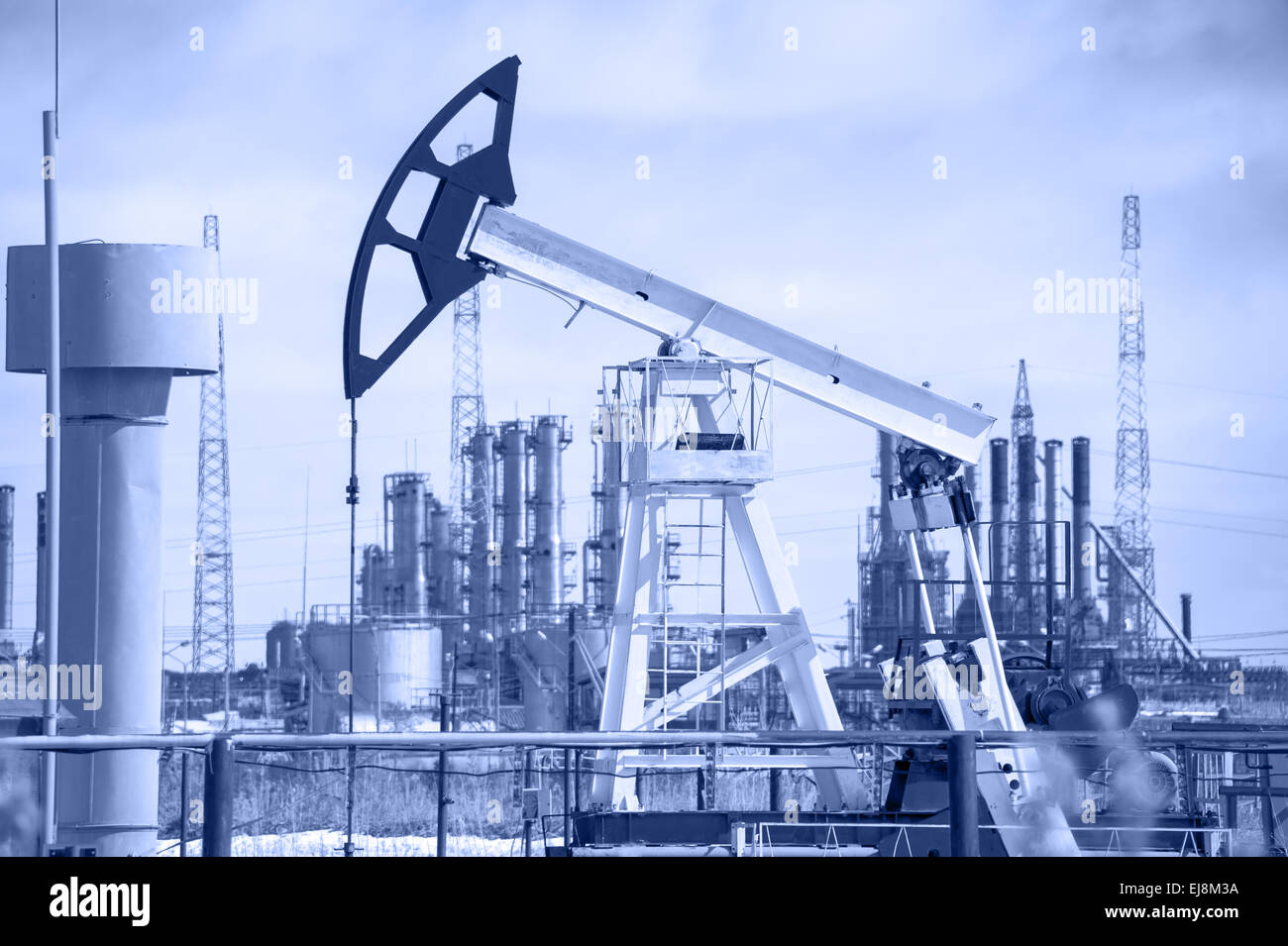 Pump jack and oil refinery Stock Photo - Alamy