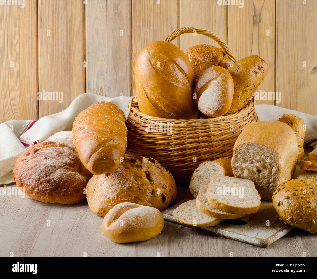 Different types of bread on a wooden background Stock Photo - Alamy