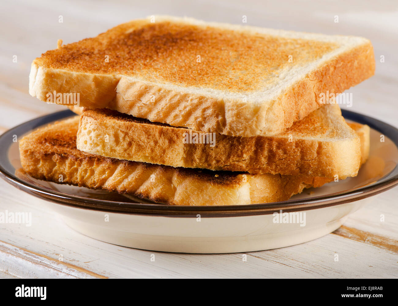 Three Slices toast bread on a wooden background Stock Photo - Alamy