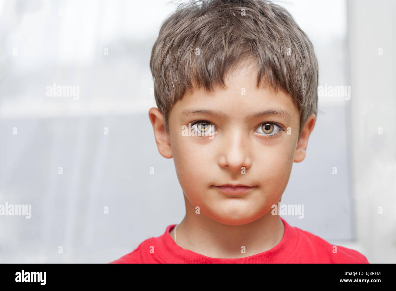 Boy in red shirt indoors closeup Stock Photo - Alamy