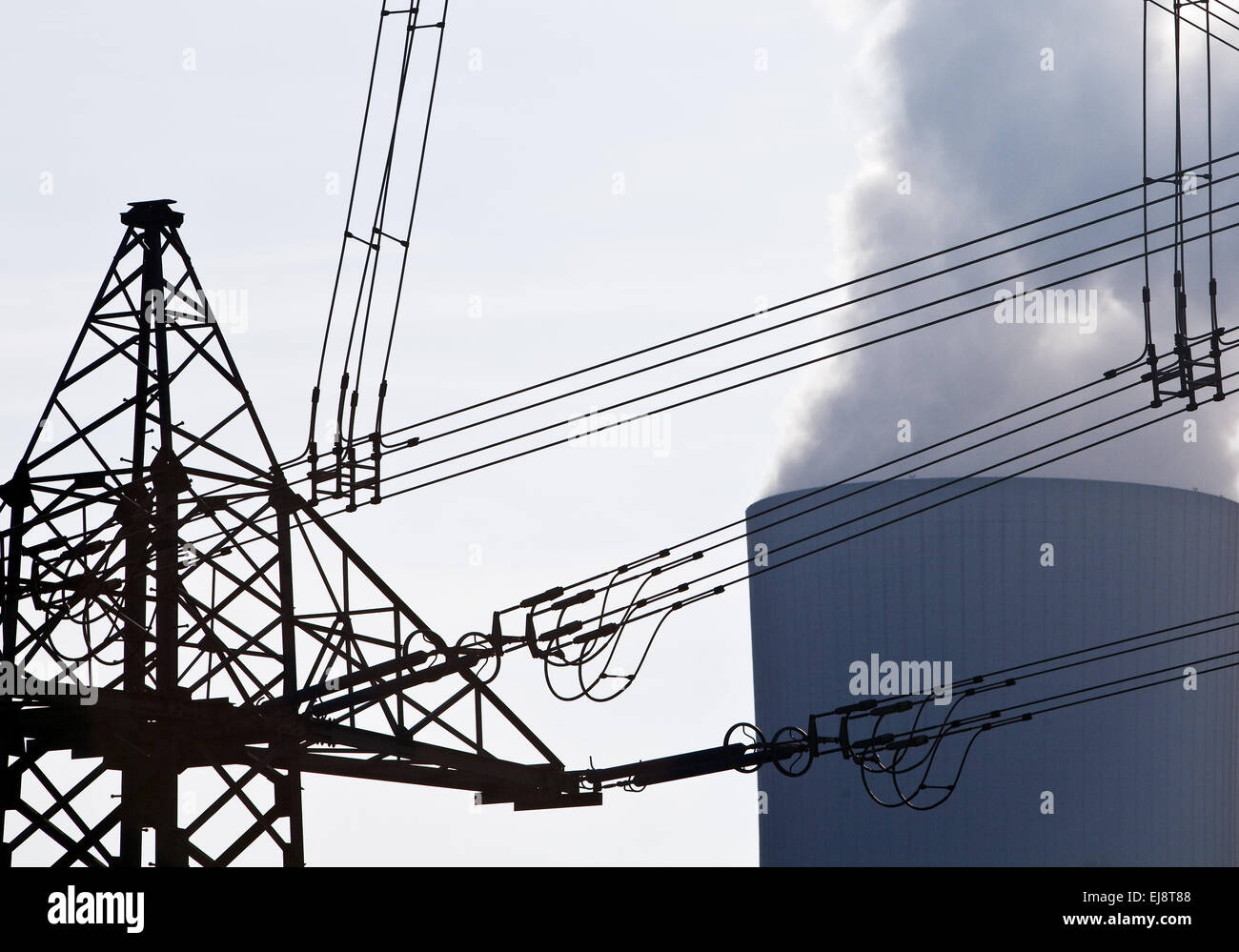 High voltage power pylons with industry Stock Photo - Alamy