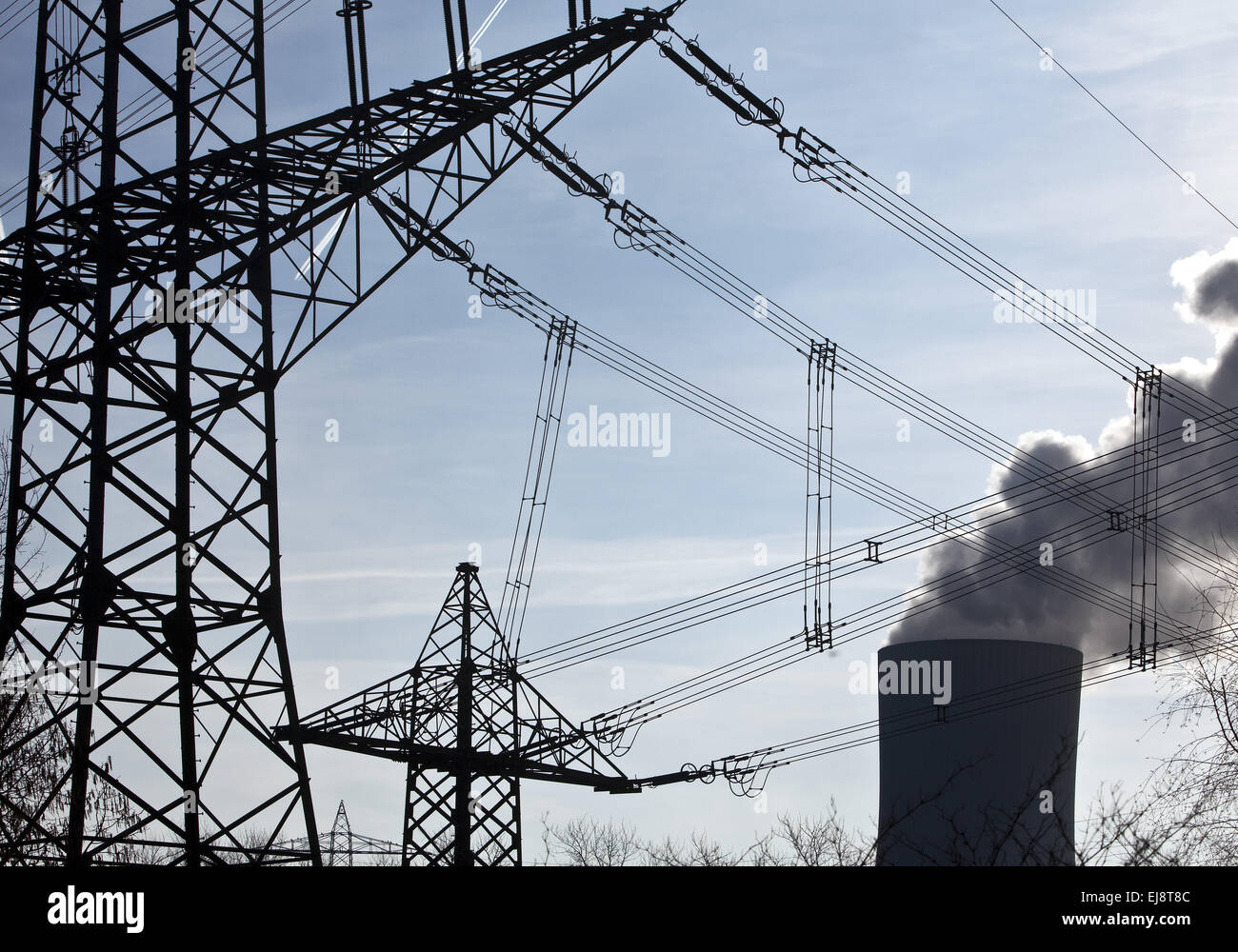 High voltage power pylons with industry Stock Photo - Alamy