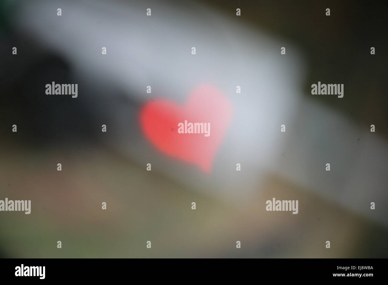 Blurred background with red heart Stock Photo - Alamy