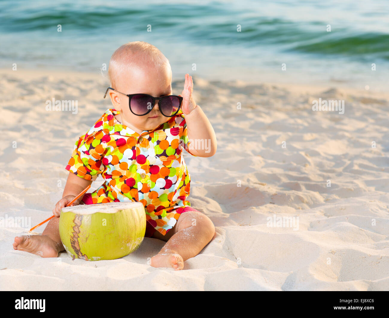 Baby with coconut Stock Photo - Alamy