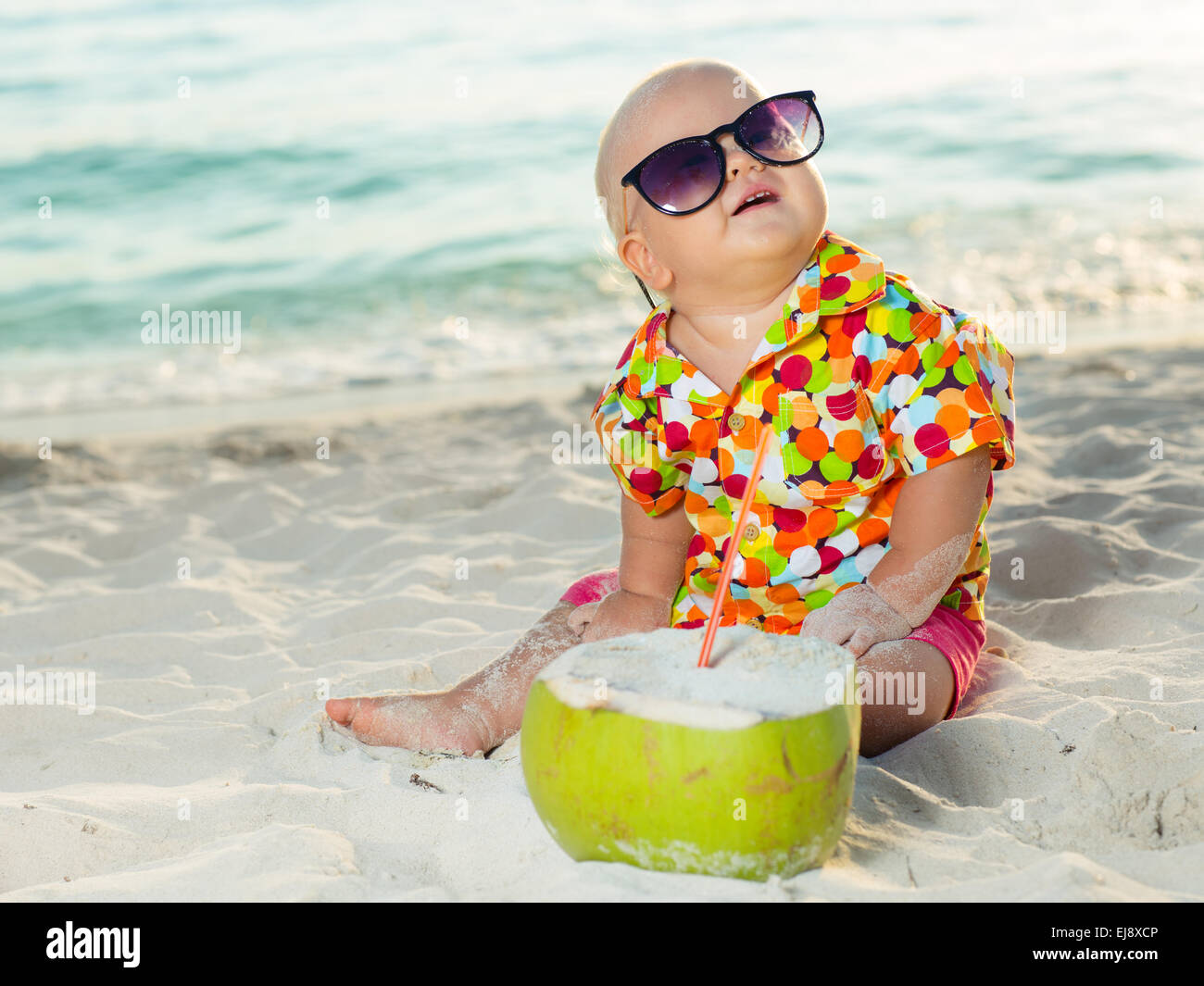 Baby with coconut Stock Photo - Alamy
