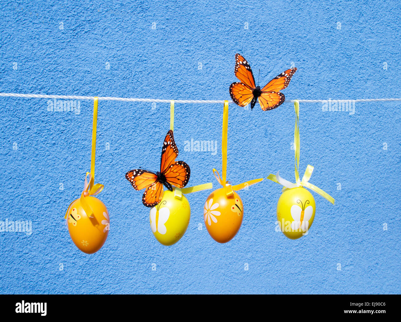 easter eggs with butterfly in blue background Stock Photo - Alamy