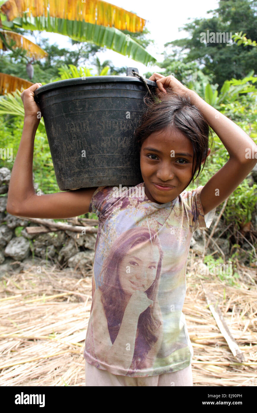 Girl carrying a bucket on Atauro Island, Timor-Leste, Asia Stock Photo ...
